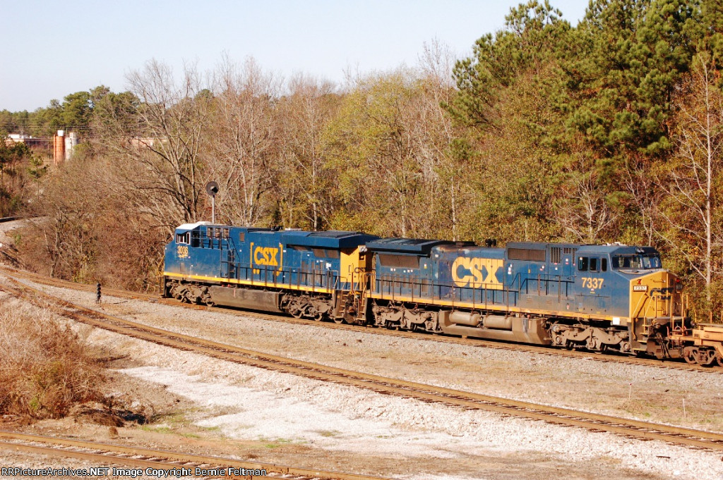 CSX ES44AC-H #3036 and C40-8W lead northbound intermodal train #Q026-13 away from the Yard ...